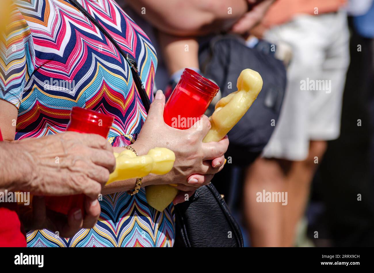 Selective focus, hands of people holding votive offerings and wax ...