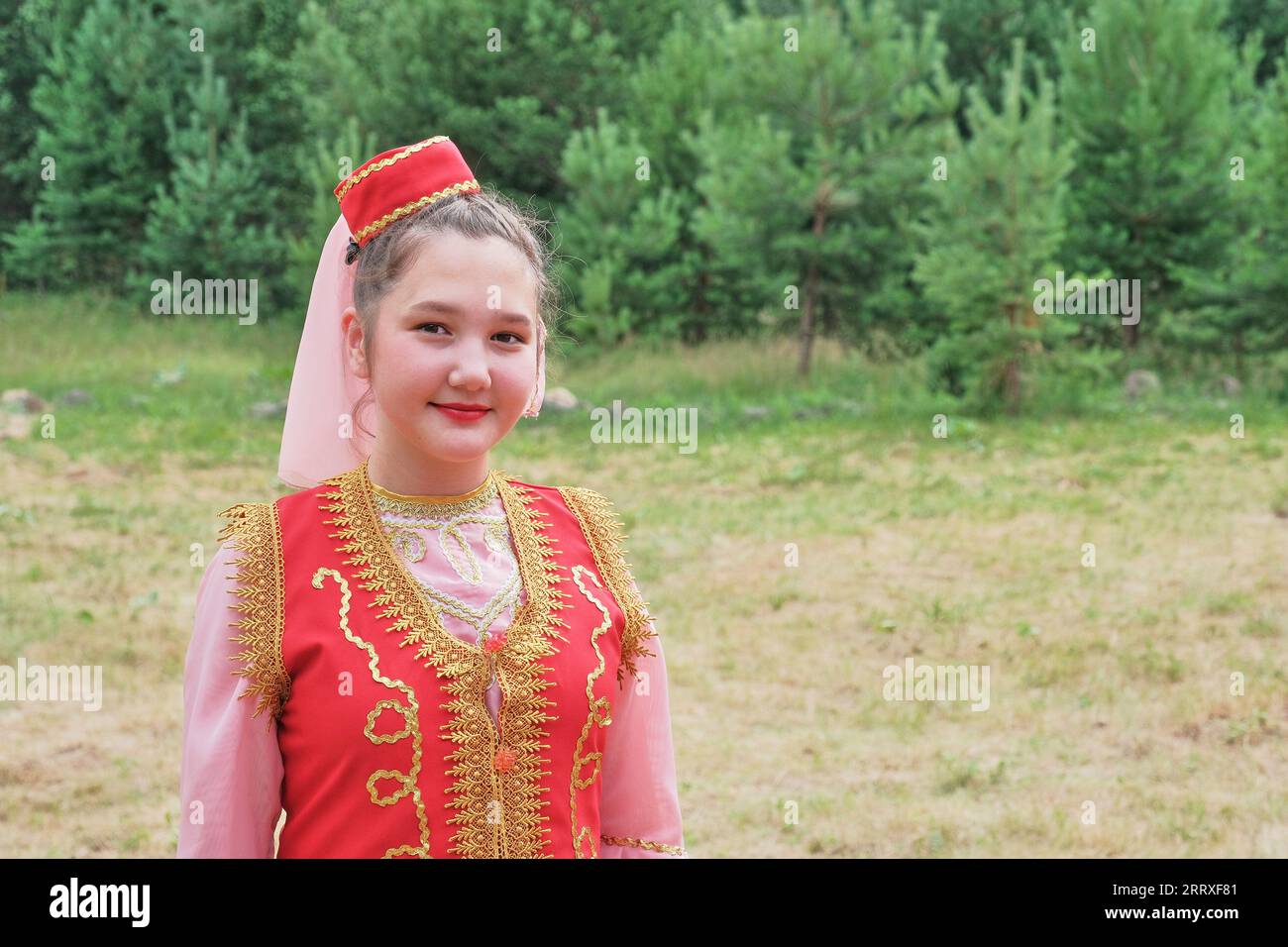 Half-lengths portrait of sweet young smiling Asian girl in skullcap and ...