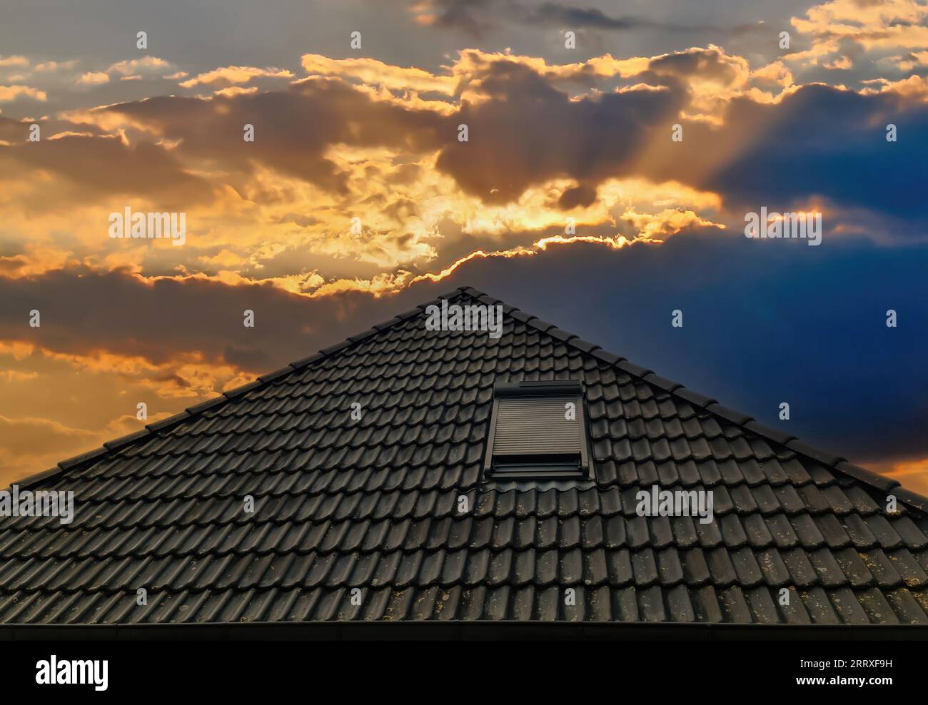 Open roof window in velux style with black roof tiles Stock Photo - Alamy
