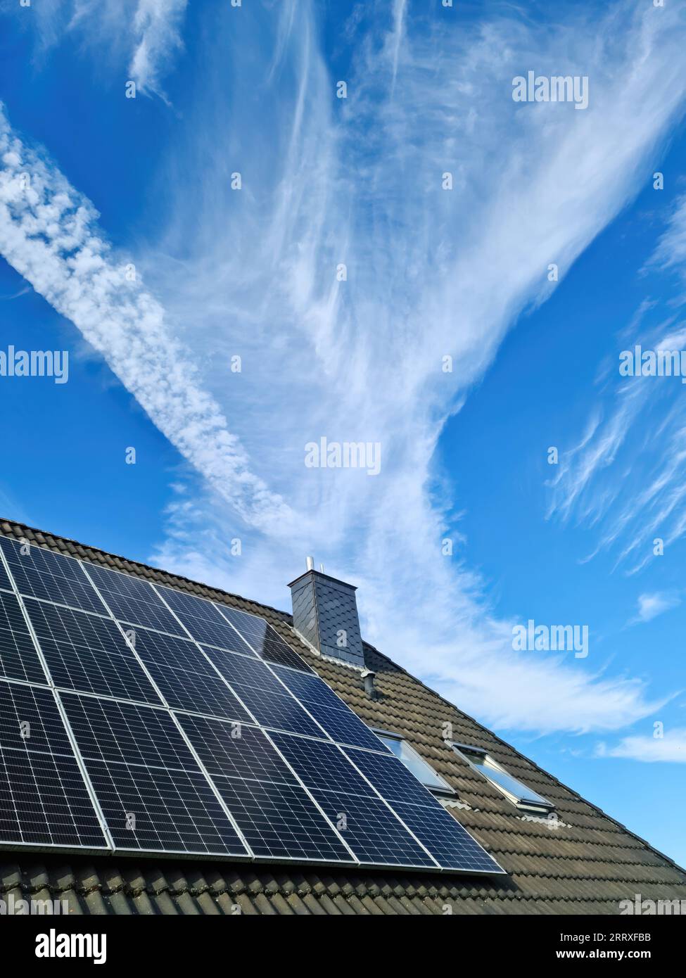 Solar panels producing clean energy on a roof of a residential house ...
