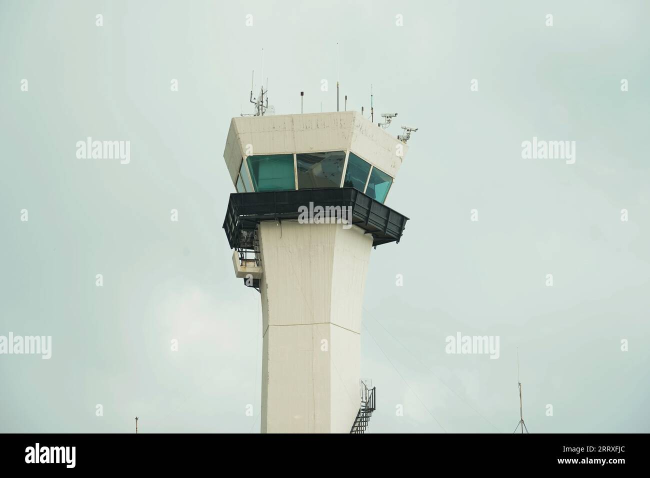 Airport control tower. The tower is a tall, windowed structure located ...