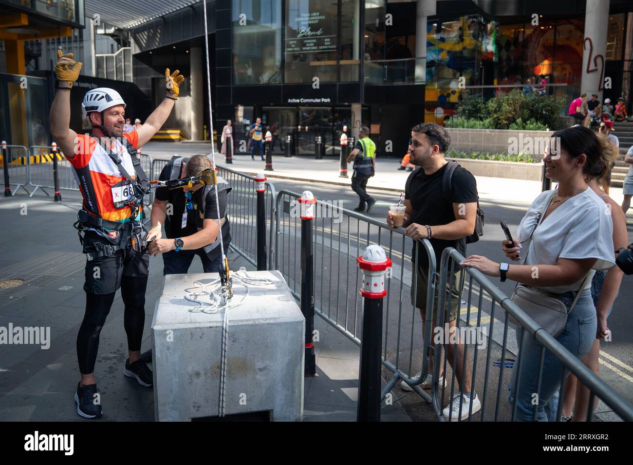 EDITORIAL USE ONLY A man celebrates after abseiling during the ...