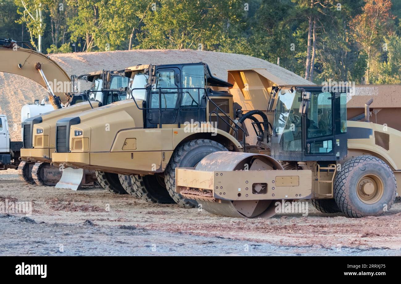 Heavy-duty trucks and equipment at a construction site near a ...