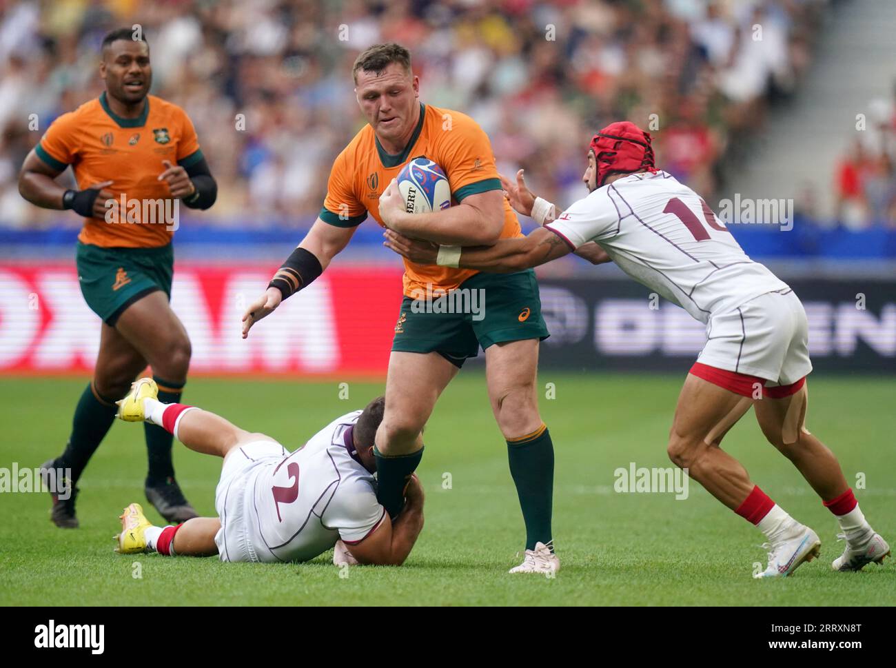 Australia's Angus Bell (centre) is tackled by Georgia's Merab ...