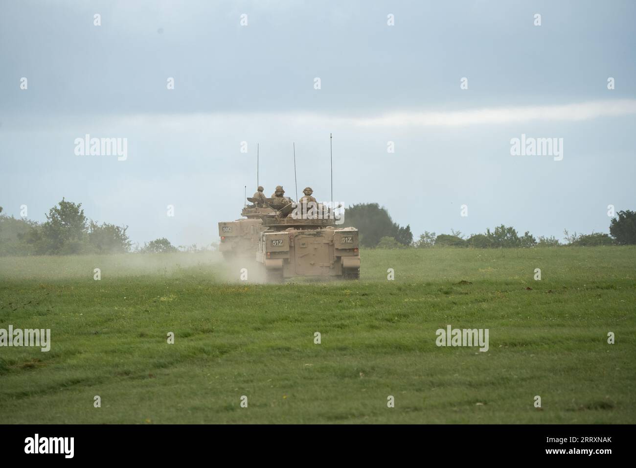 British army Warrior FV510 Fighting Vehicle Tank moving across a grass ...