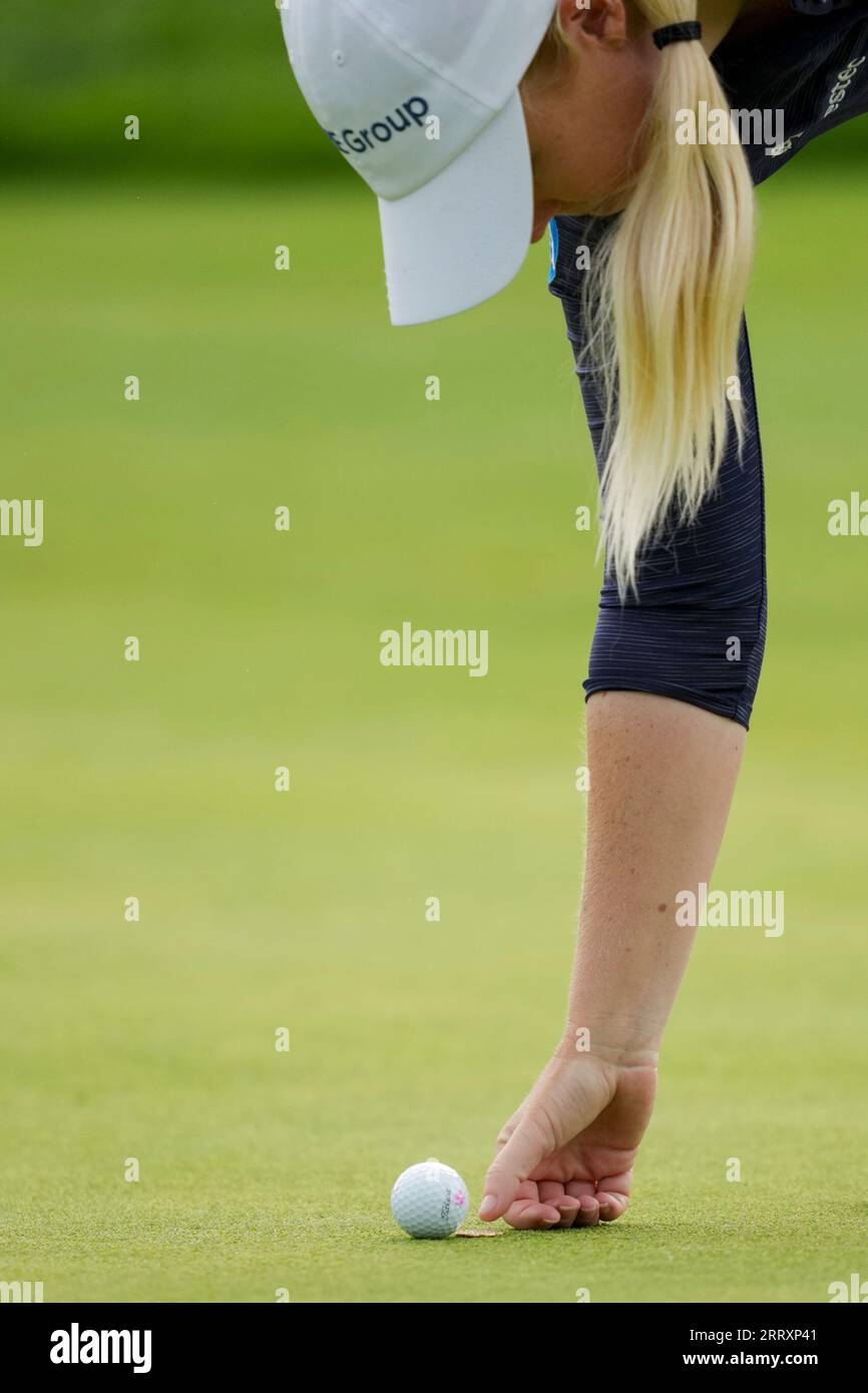 Stephanie Meadow, of Northern Ireland, places a ball marker on the ...