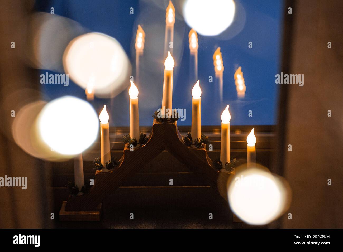 advent candlestick on window sill at night Stock Photo - Alamy