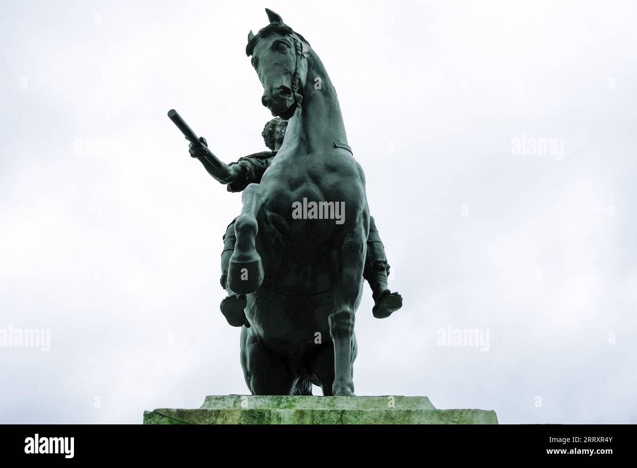 A bronze statue depicting a man on horseback, brandishing a firearm in ...