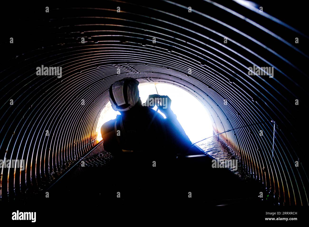 Canoeing through na culvert with a pull-rope in the Adirondack ...