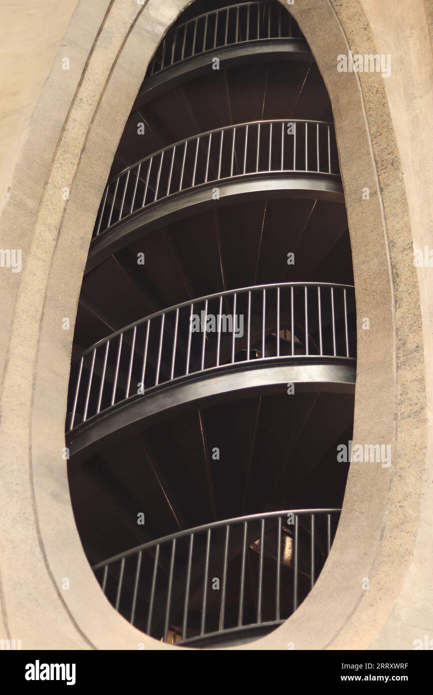 An arched window provides a view of a grand building with multiple ...