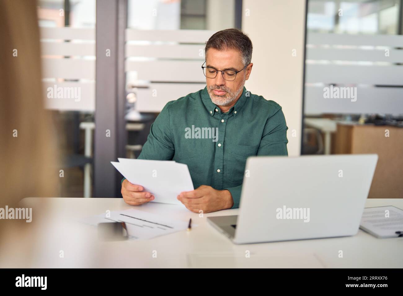 Mature business man hr manager checking cv at office meeting interview ...
