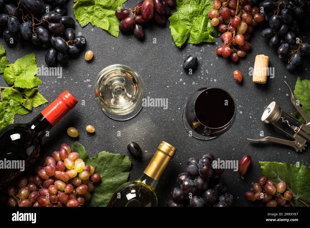 Glass of wine, bottle and fresh crape on black Stock Photo - Alamy