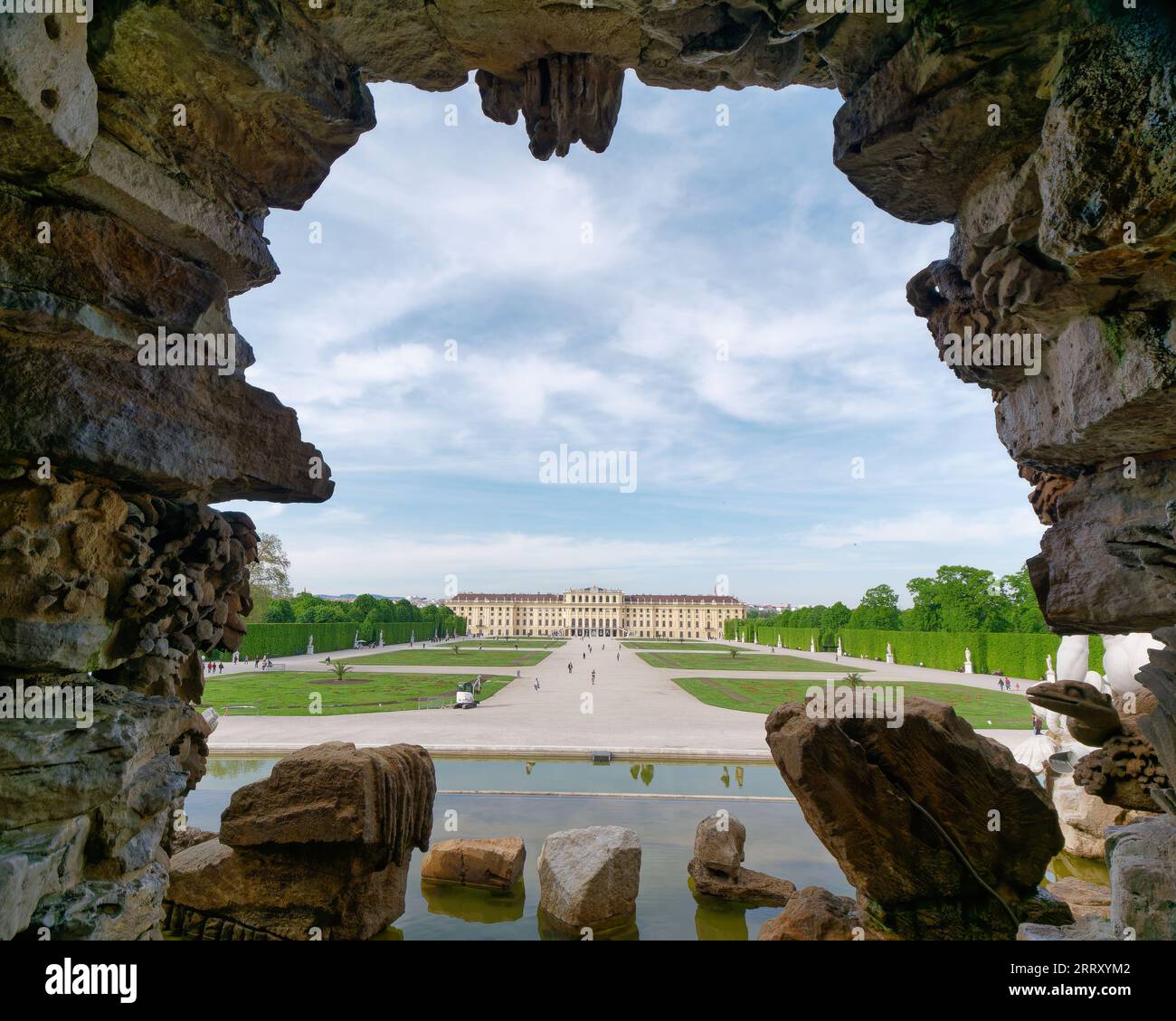 A scenic stone wall, featuring a tranquil park and a small body of ...