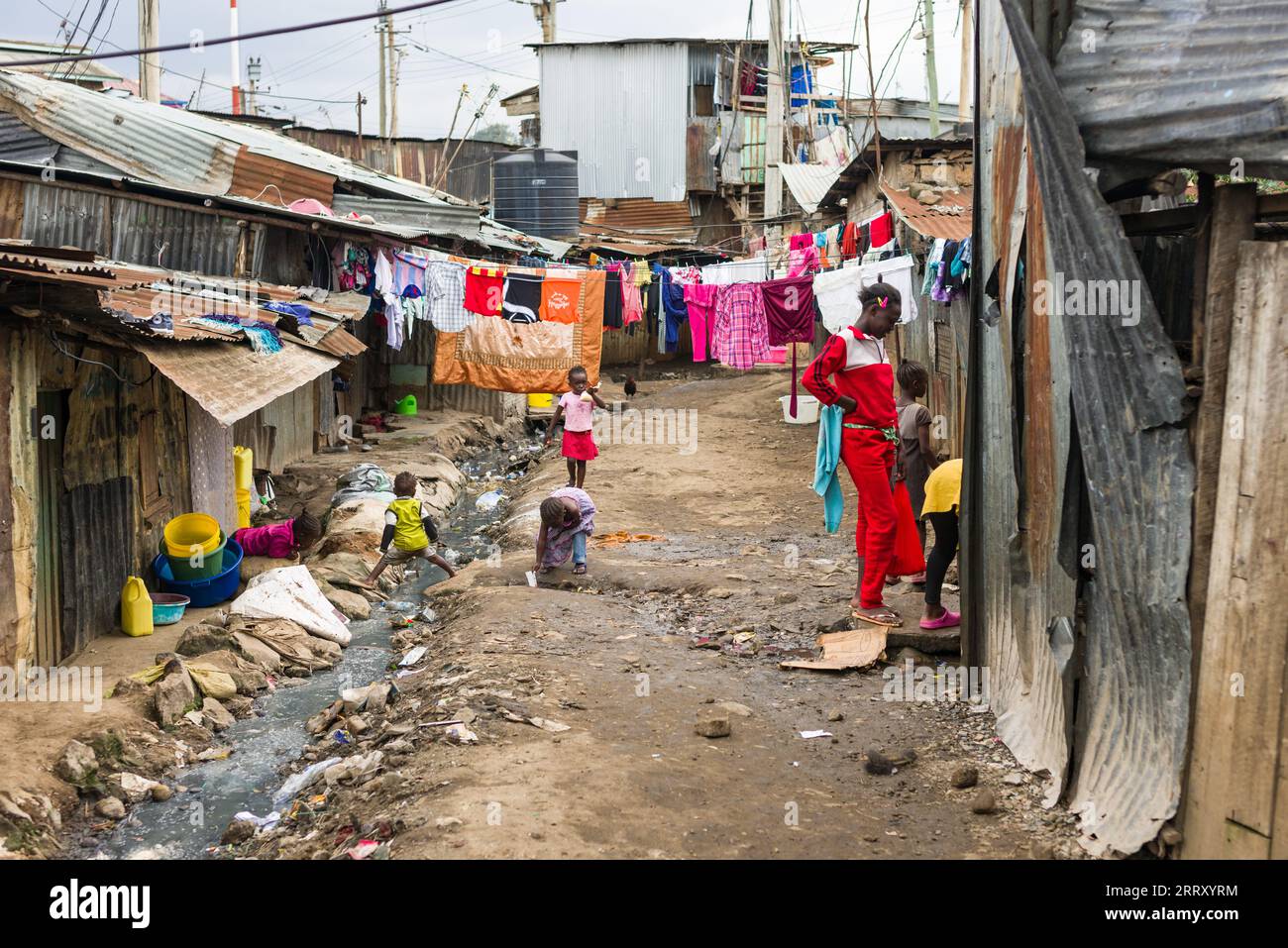View down a side path with corrugated metal shack buildings, with ...