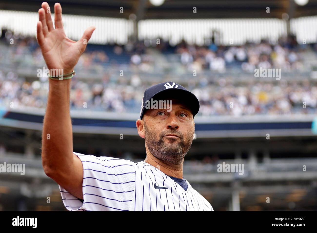 Former New York Yankees' Derek Jeter waves during Yankees Old-Timers' Day ceremony before a ...