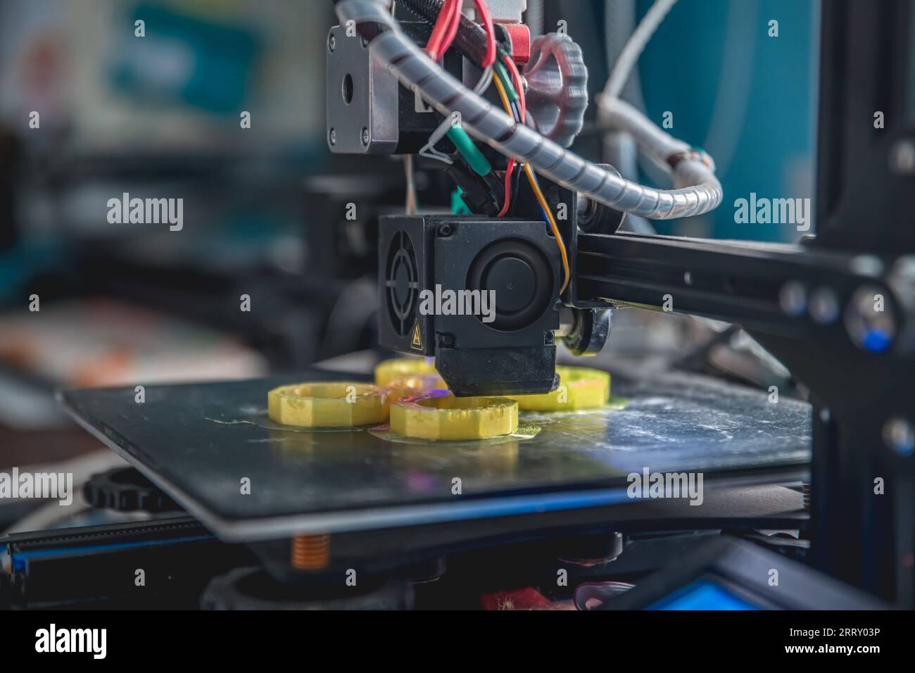 3D printer prints a model made of yellow plastic Stock Photo - Alamy