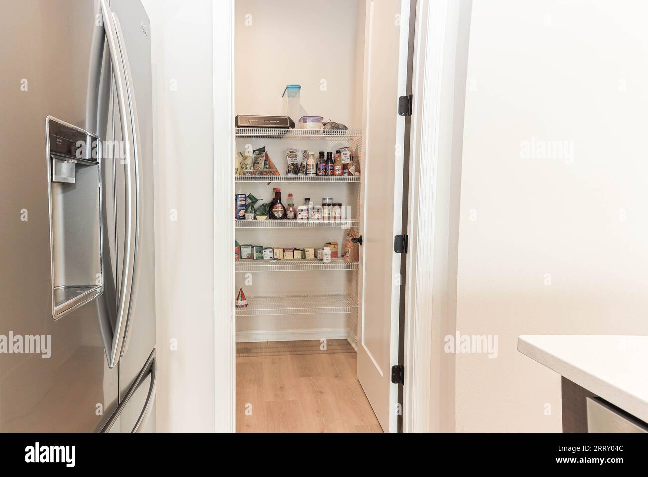 A spacious and well-stocked pantry with a variety of food items ...