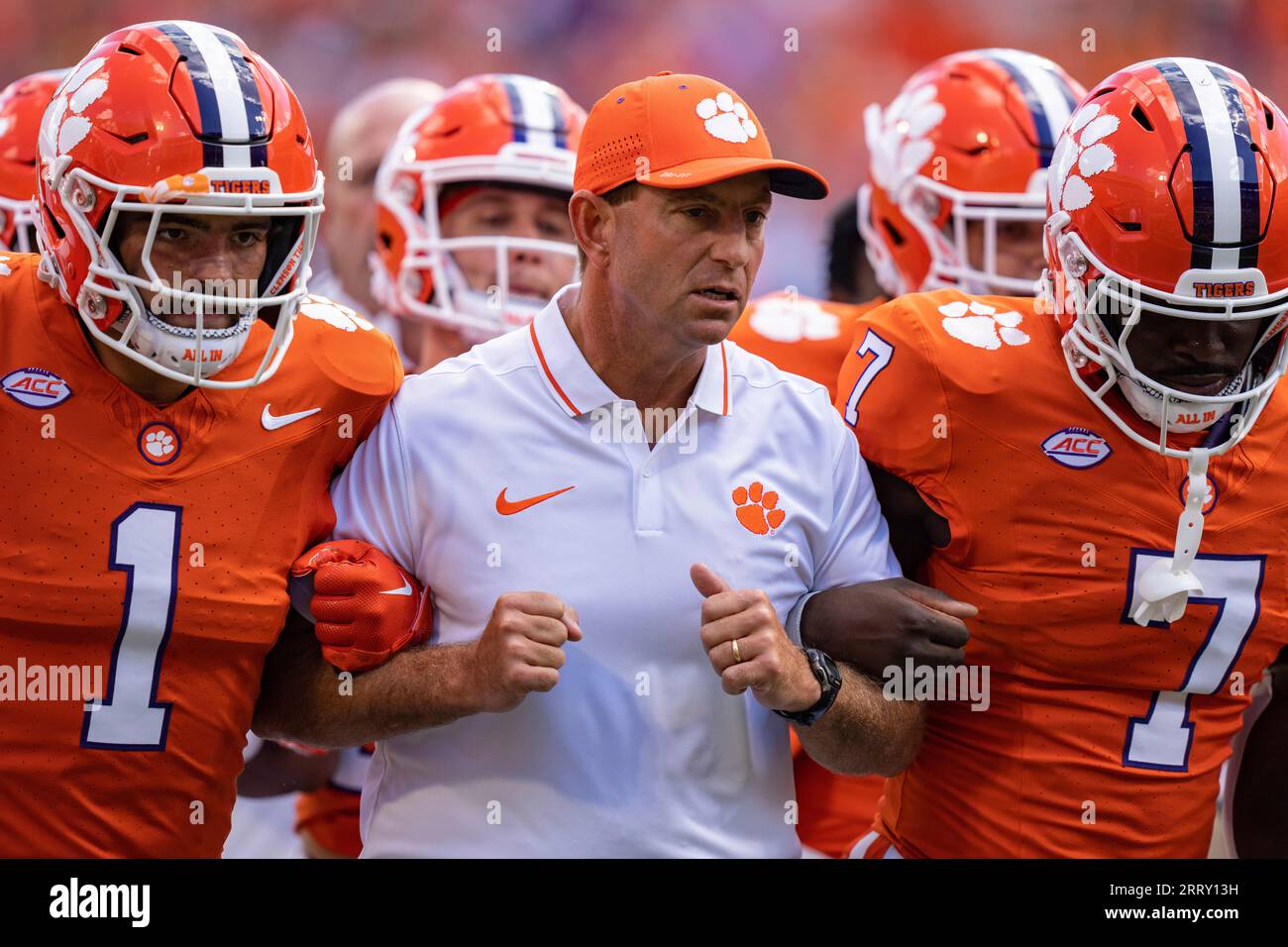 Clemson head coach Dabo Swinney walks arm in arm with his players ...