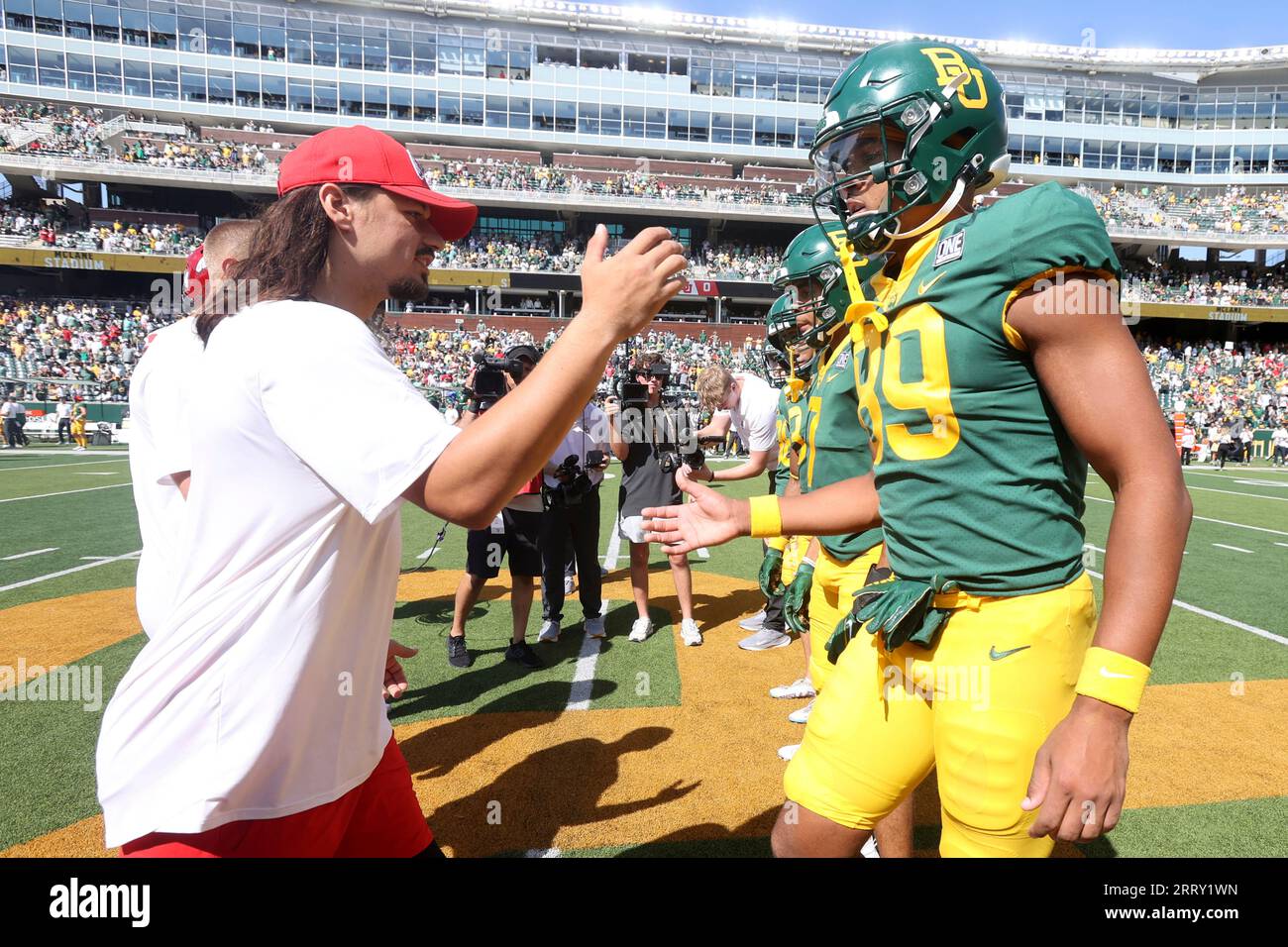Utah quarterback Cameron Rising, left greets Baylor tight end Drake ...