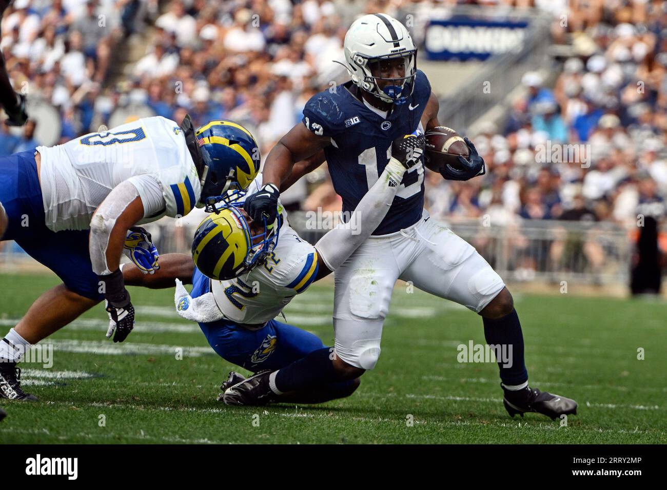 Penn State running back Kaytron Allen (13) fends off Delaware defensive ...