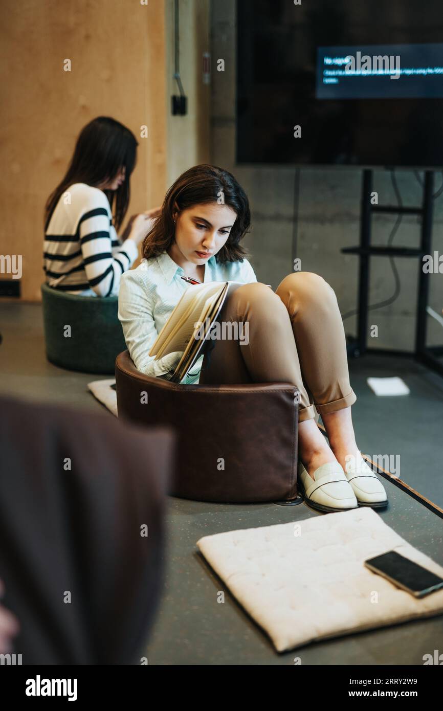 Junior employees having training at work. Business girl solving ...