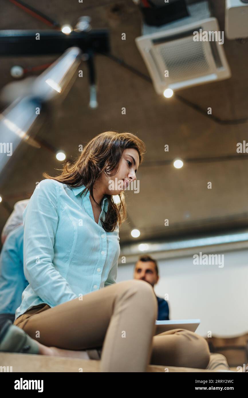 Low-angle of a young and beautiful businesswoman formally dressed ...