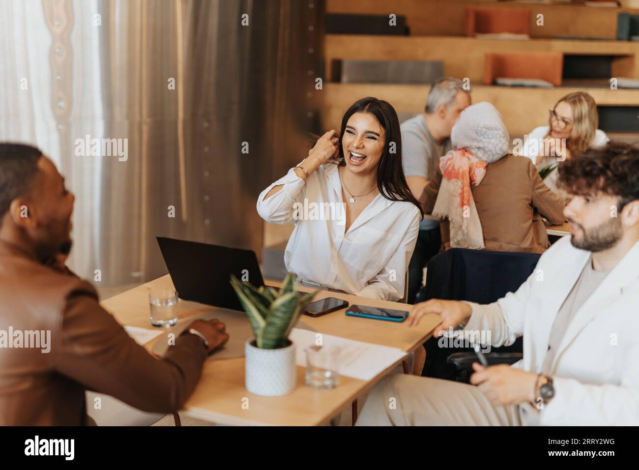 Beautiful business colleagues having fun conversation. Brunette girl ...