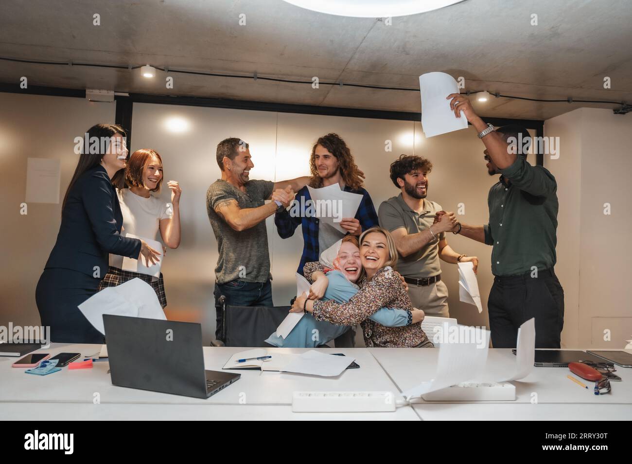 Different aged, multiracial business people hugging each other ...