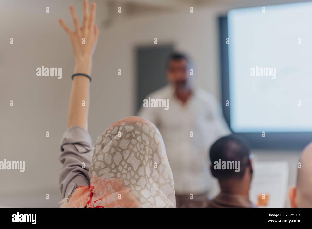 Back view photo of muslim woman raising hand to ask question Stock ...