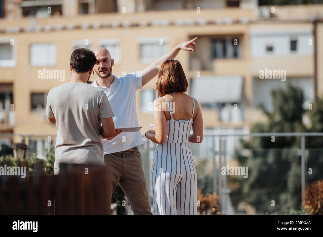 A Group Of Architects And Construction Engineers Discuss And Analyze A Blueprint On A Table