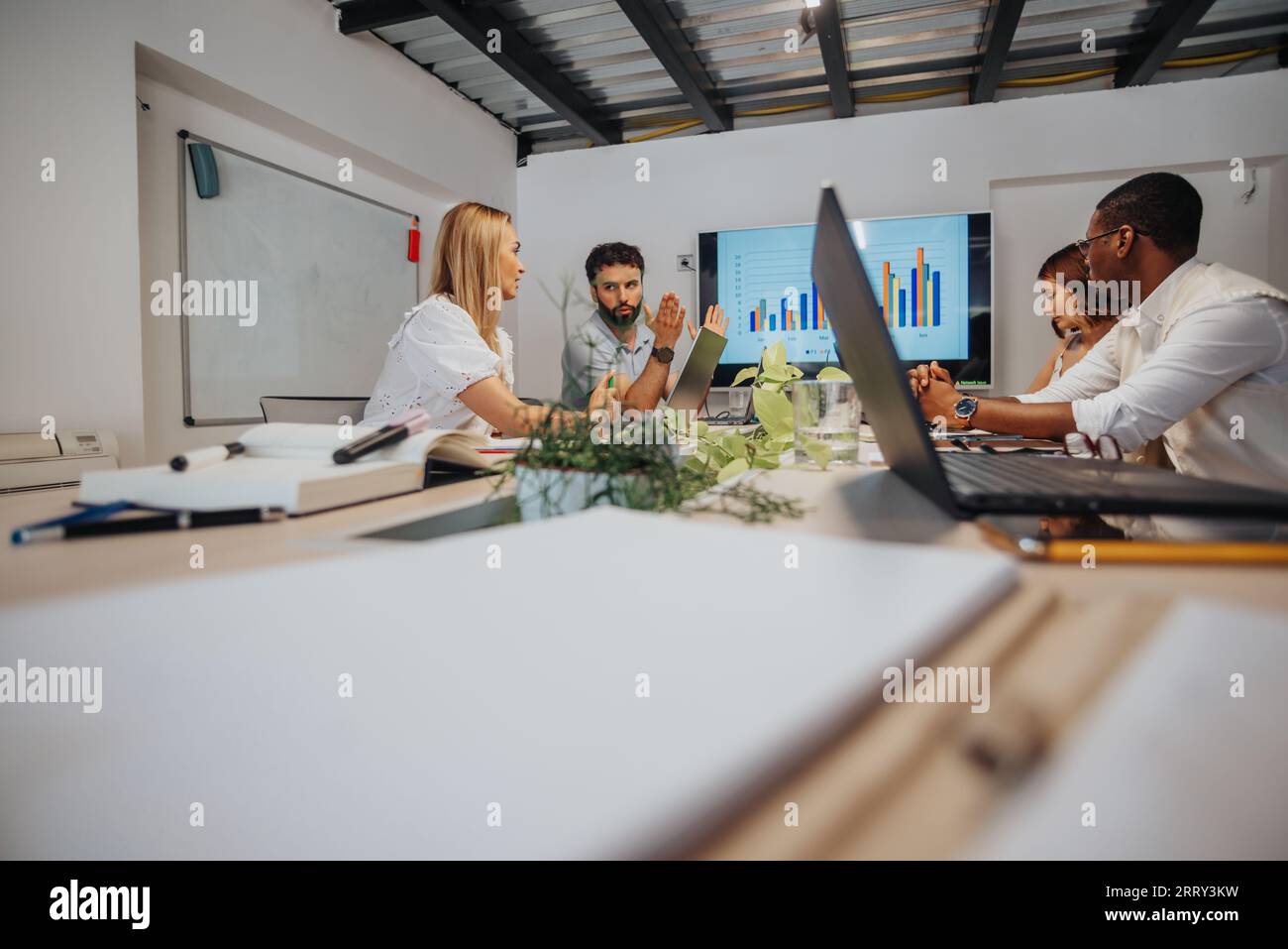 A diverse group of businesspeople discuss, collaborate, and problem ...