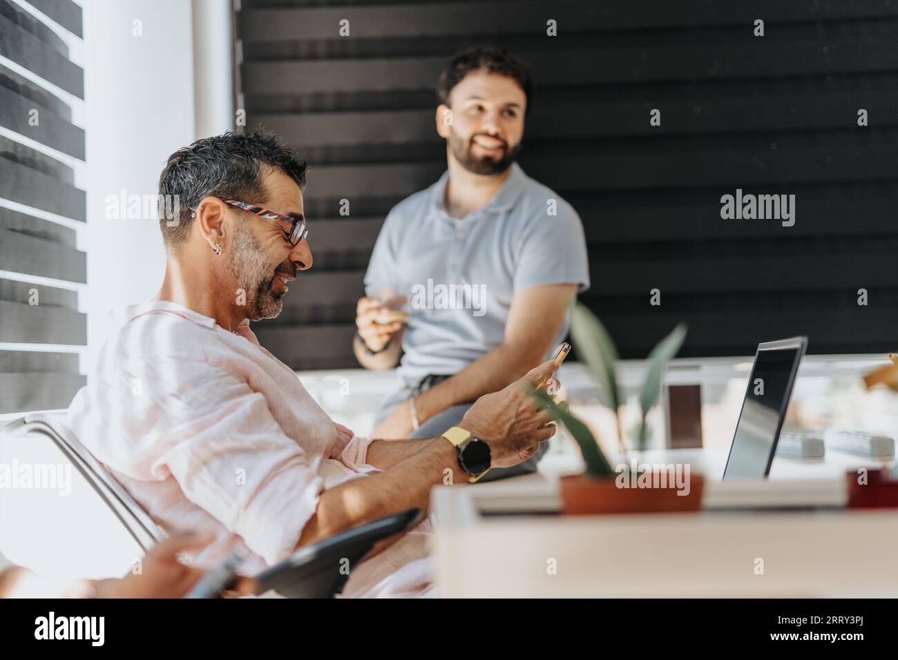 Various generation coworkers working in a positive atmosphere at modern ...