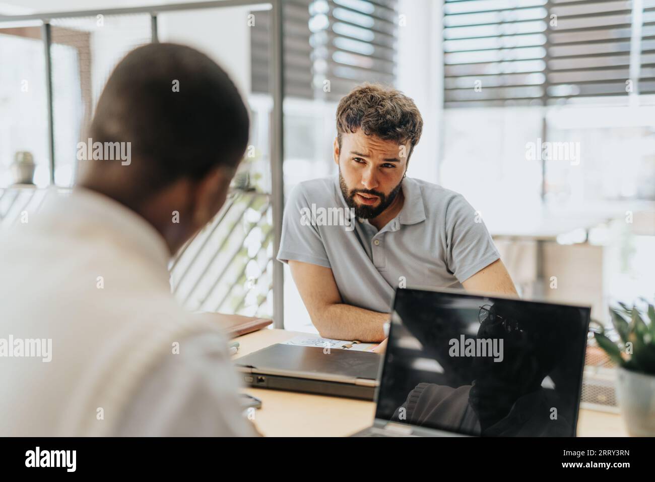 Marketing professionals collaborate in a diverse office, focusing on ...