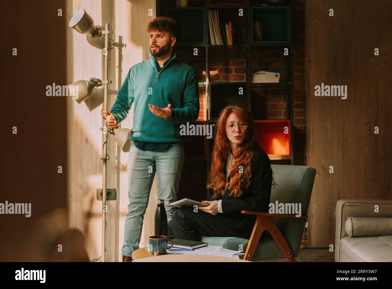 Young worried business people having problems with some calculations in ...