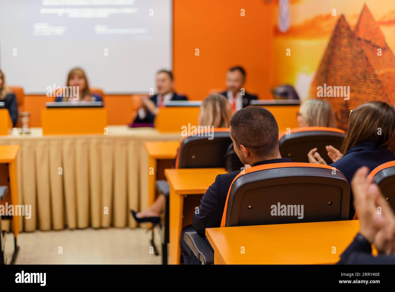 Professors and students applauding their classmate after giving a ...