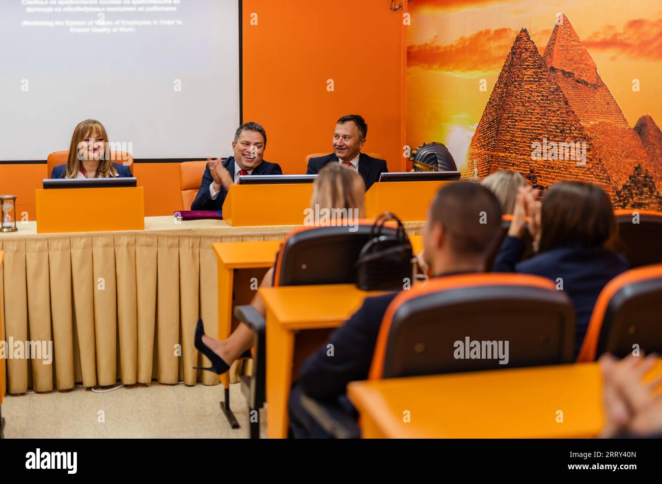 Professors and students applauding their classmate after giving a ...