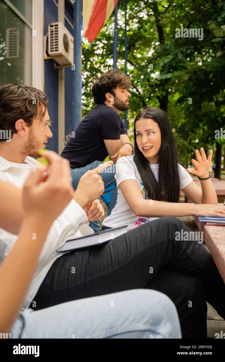 In a bustling campus yard, university students collaborate, discuss and ...