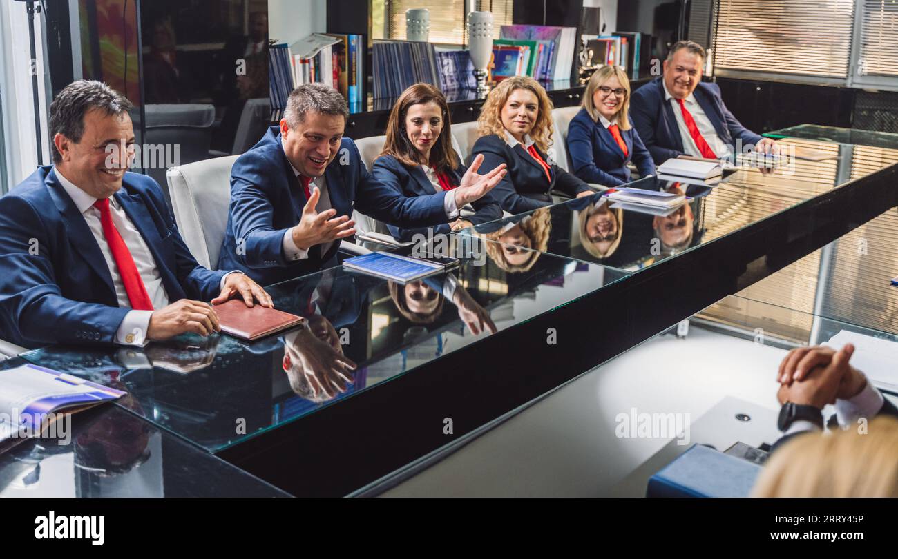 Middle-aged university professor joking with his colleagues during ...