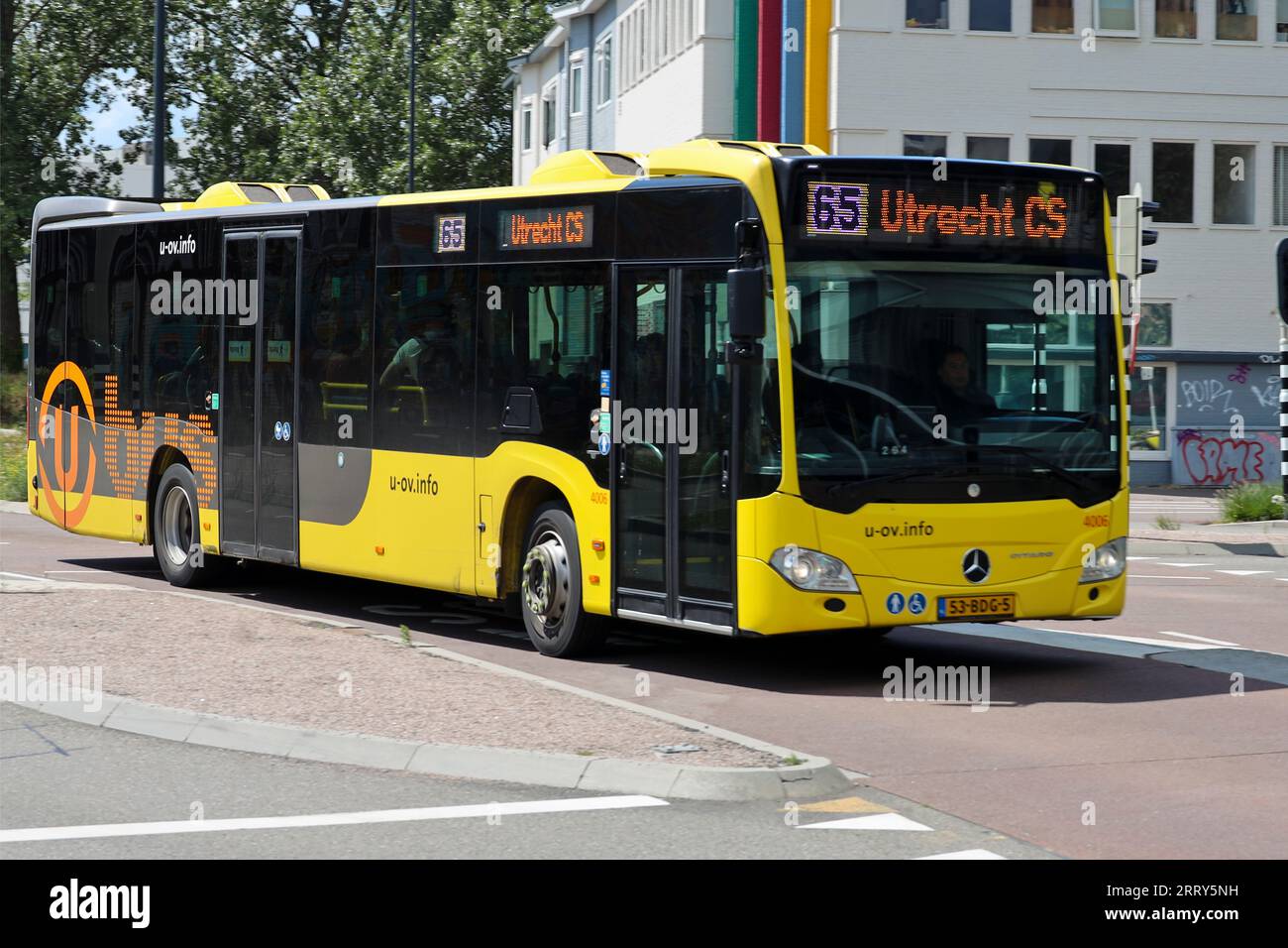 Articulated city bus in yellow colour of U-OV in the city of Utrecht ...