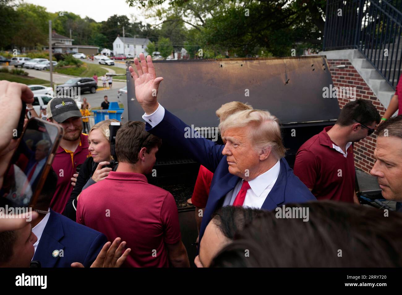 Former President Donald Trump waves during a stop at the Alpha Gamma ...