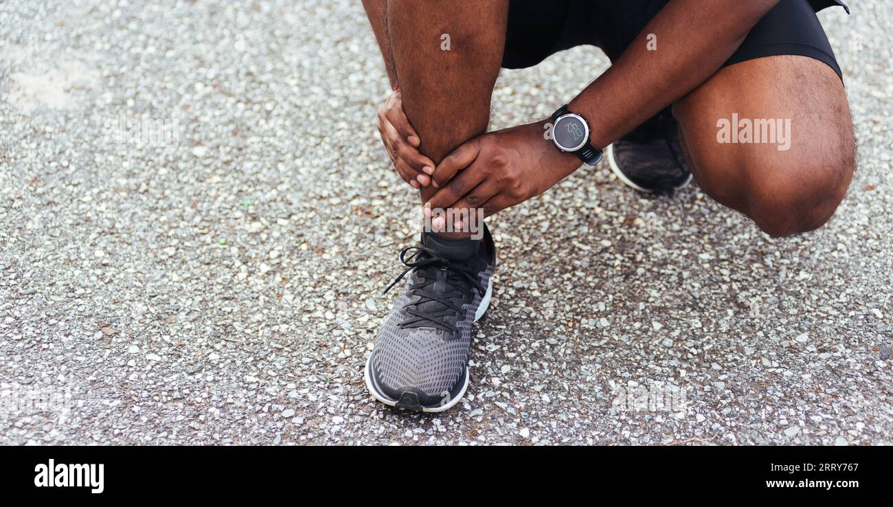 sport runner man use hands joint hold leg pain because of twisted ankle ...