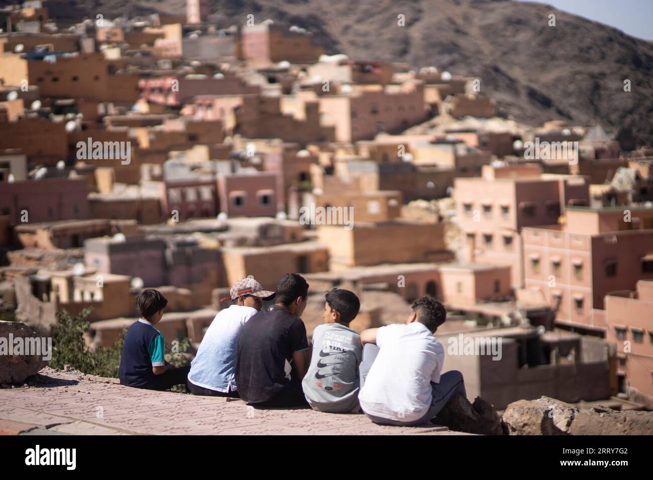 Kids observe a view of their home area Moulay Brahim, which was damaged ...