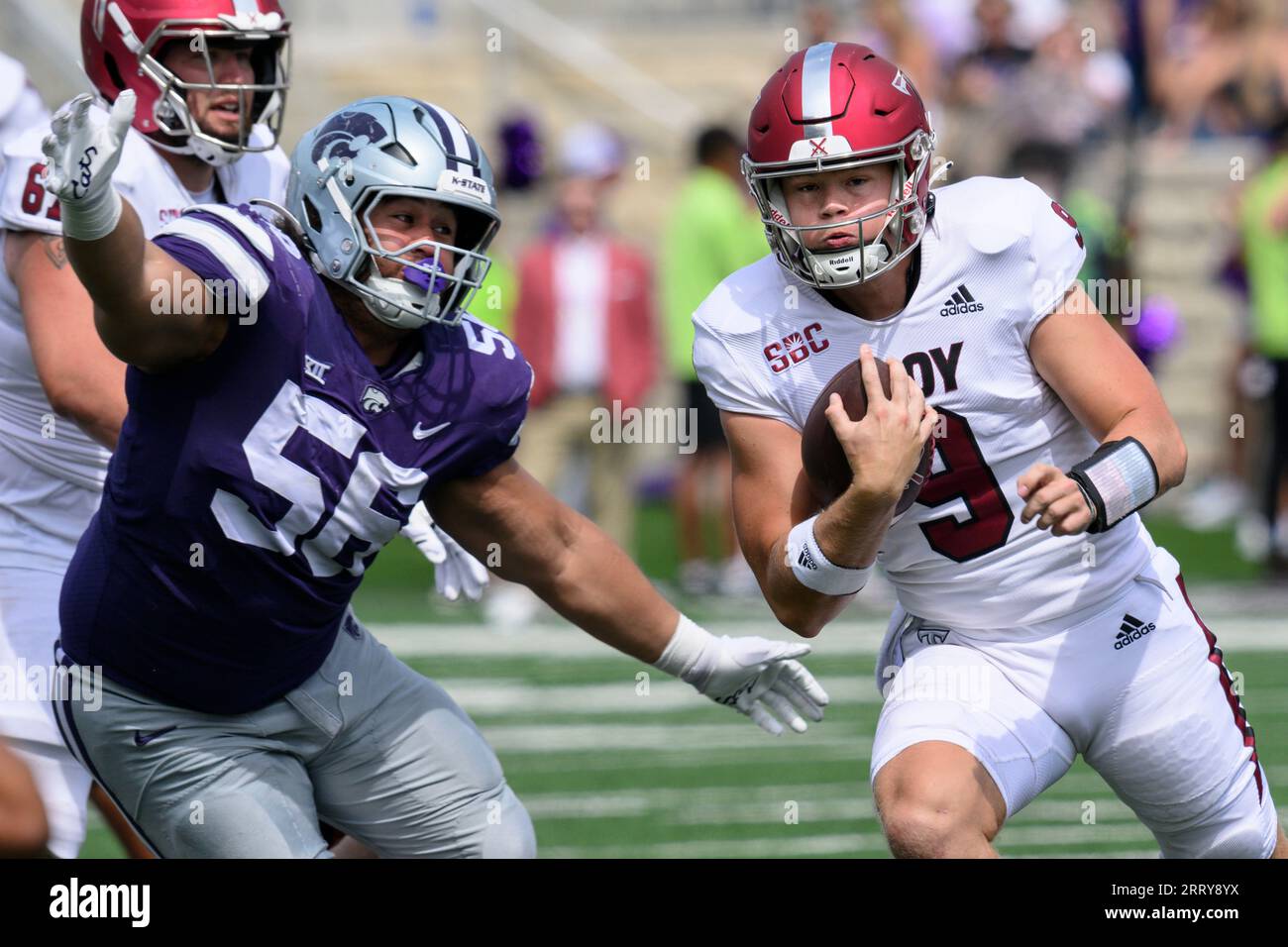 Troy quarterback Goose Crowder (9) is chased by Kansas State defensive ...