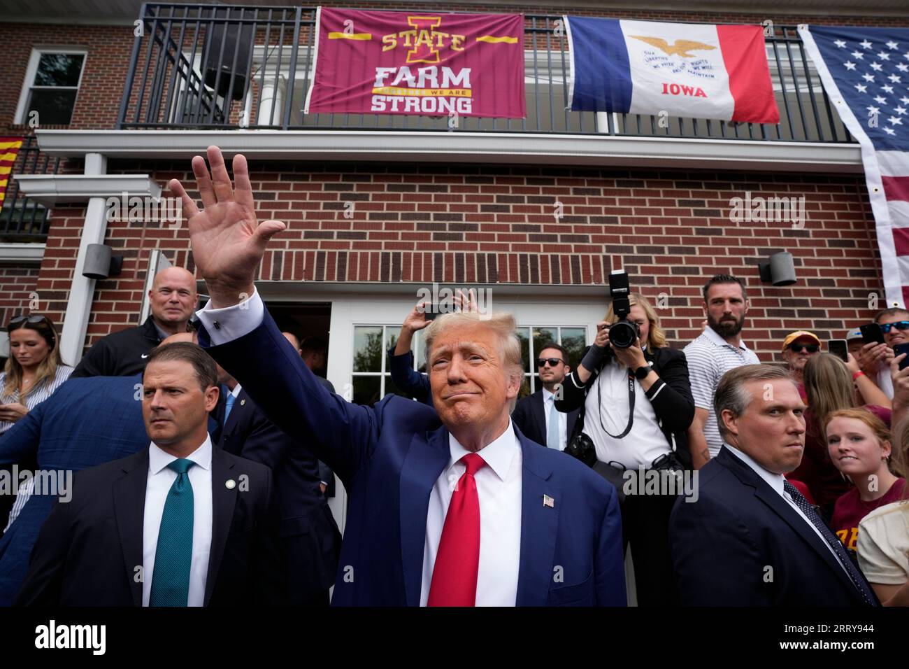 Former President Donald Trump waves as he visits the Alpha Gamma Rho ...