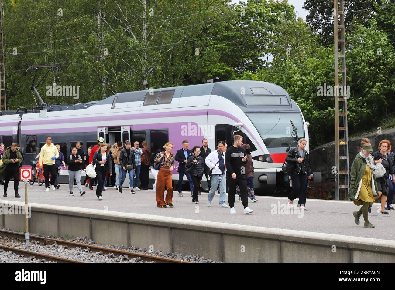 Helsimki, Finland - September 5, 2023: Passenger disembarking the HSL commuter train class Sm5 ...