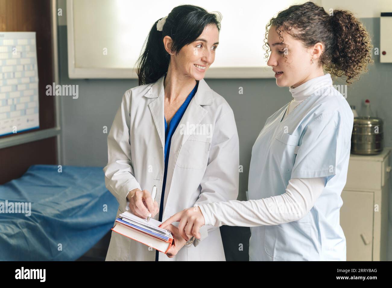 Doctor with medical student explaining treatment both in hospital ...