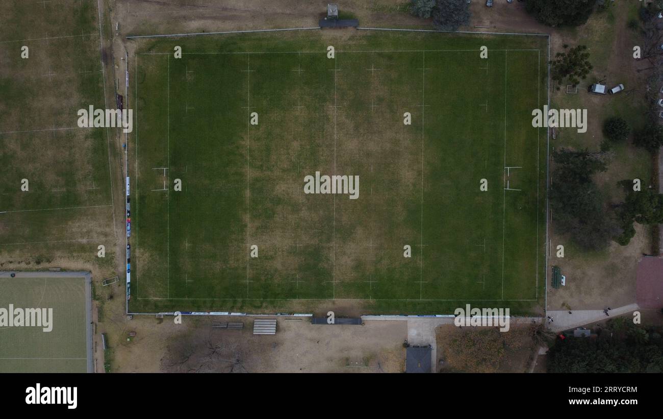 This aerial image showcases a lush green soccer field, nestled between ...