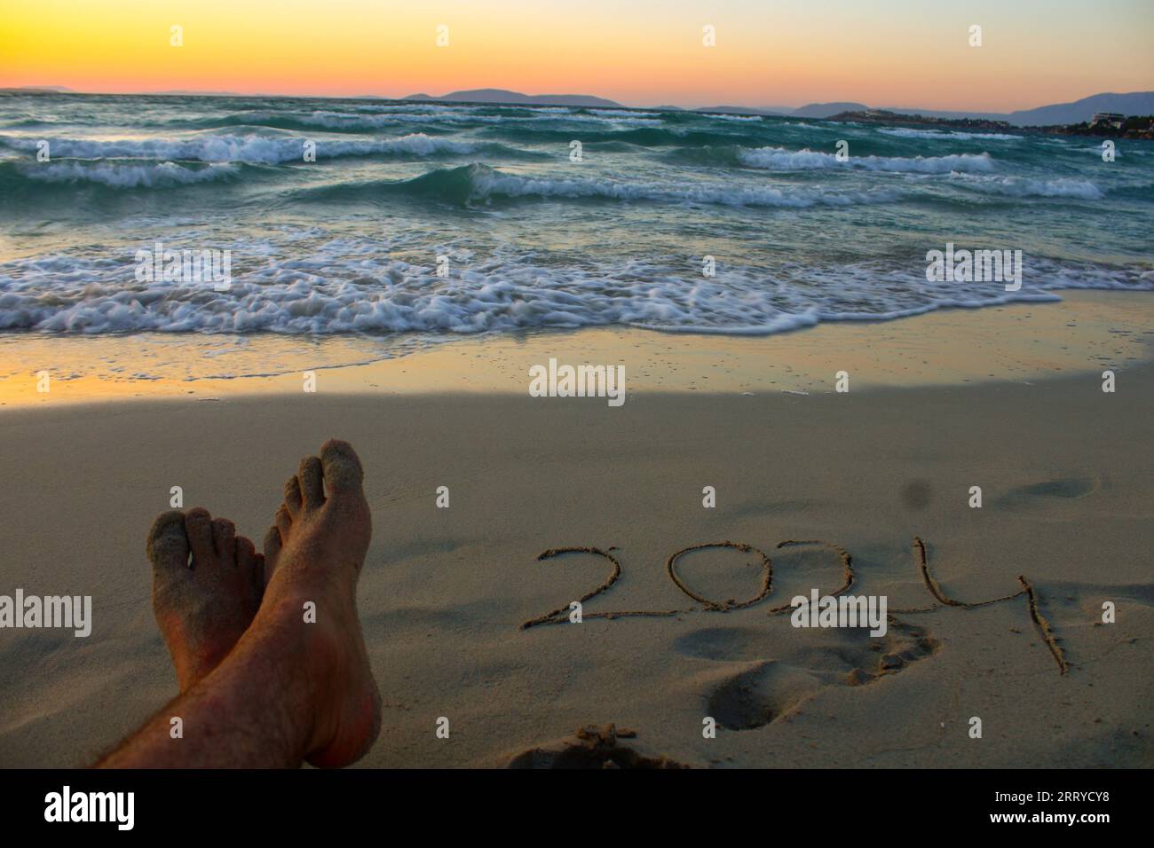 The number 2024 written in the sand on the beach. new year 2024 concept ...