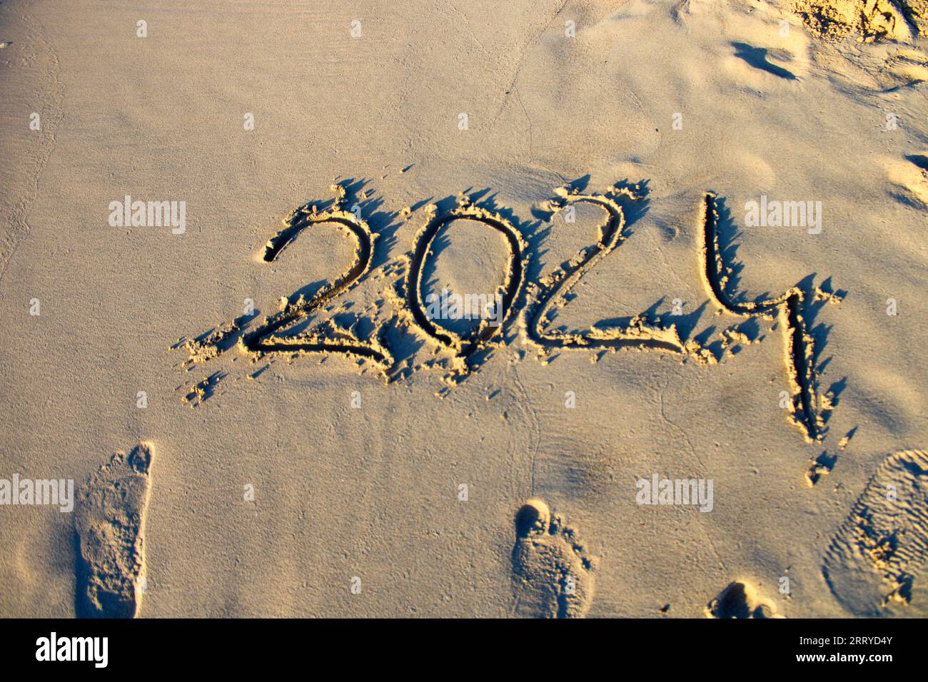 The number 2024 written in the sand on the beach. new year 2024 concept ...