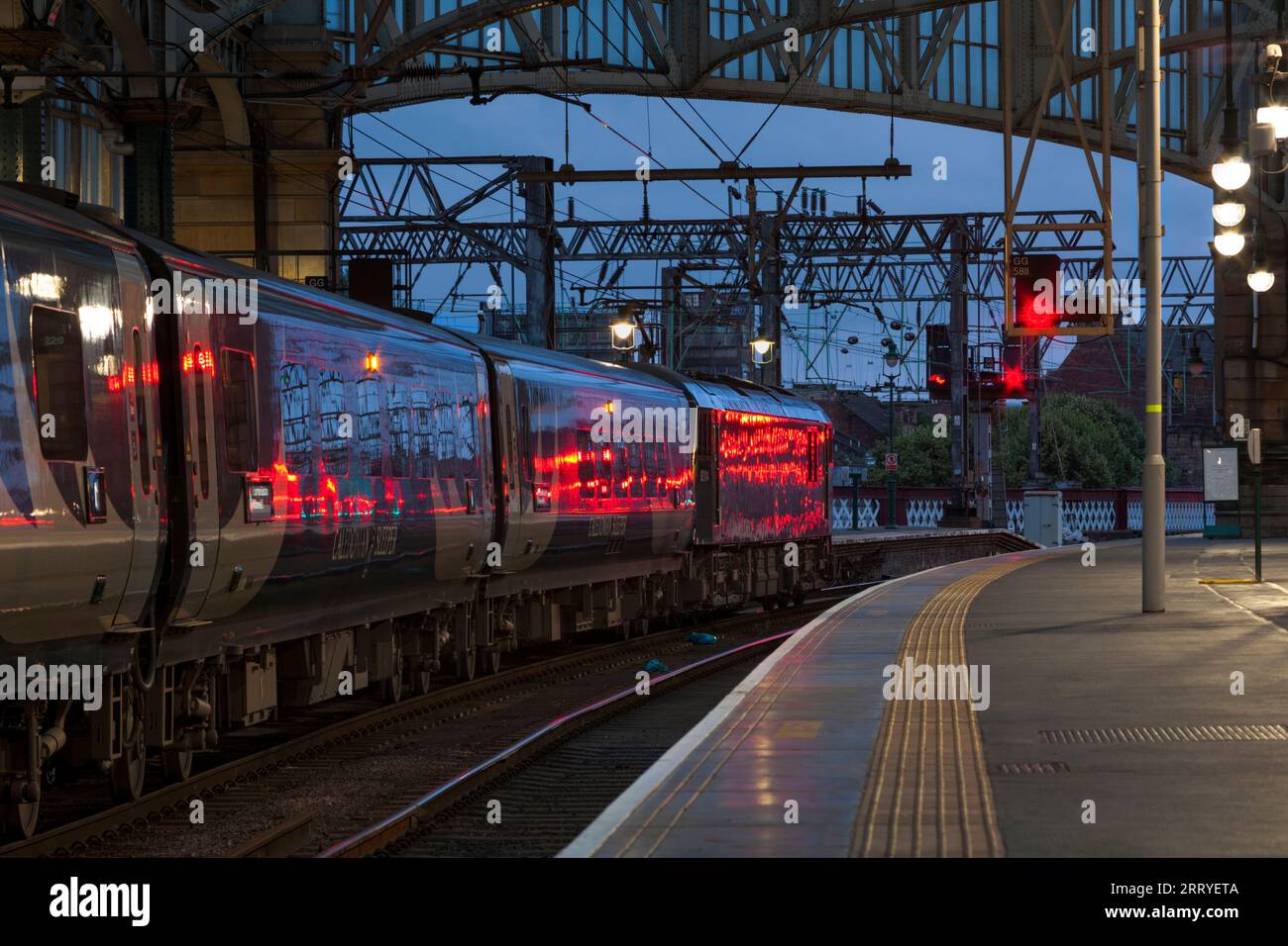 The lowland Caledonian sleeper train waiting to depart from Glasgow Central station with a red ...